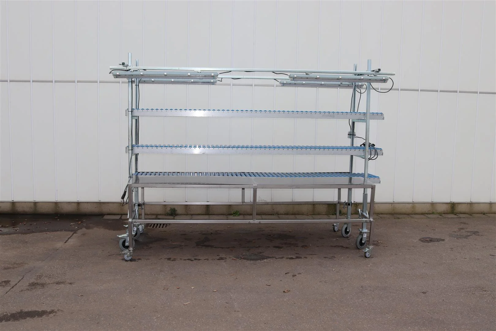Double stainless steel tables with 3 roller conveyors • Duijndam Machines