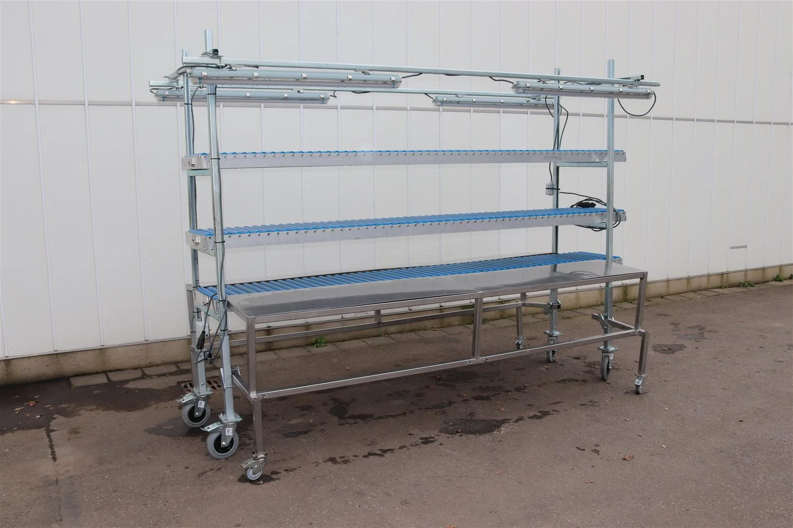 Double stainless steel tables with 3 roller conveyors • Duijndam Machines